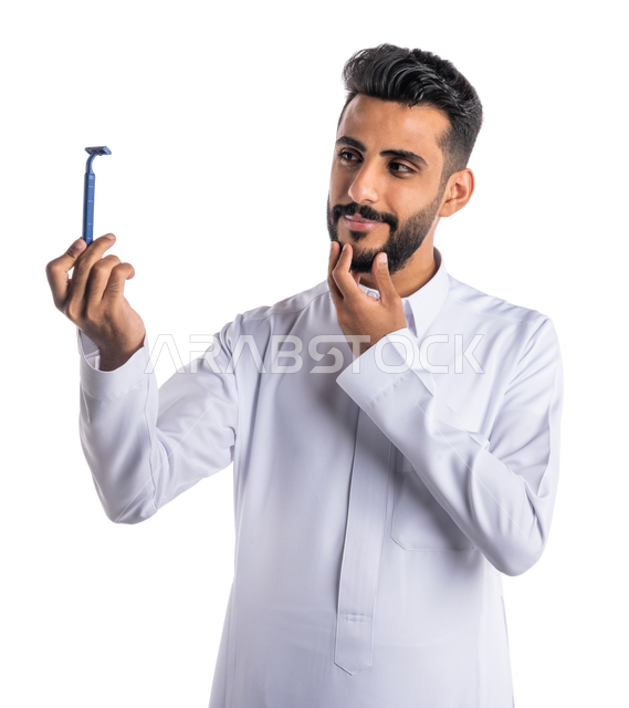 Close-up portrait of a Saudi Arabian Gulf man, holding a razor blade in ...