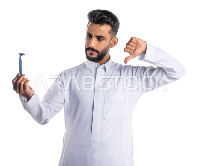 Portrait of a close-up of a Saudi Arabian Gulf man, holding a razor ...
