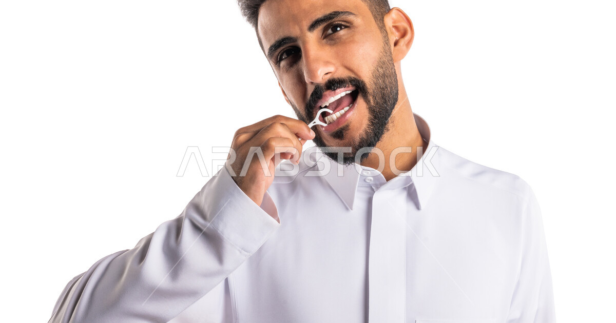 Close-up portrait of a Saudi Arabian Gulf man, using a toothpick ...