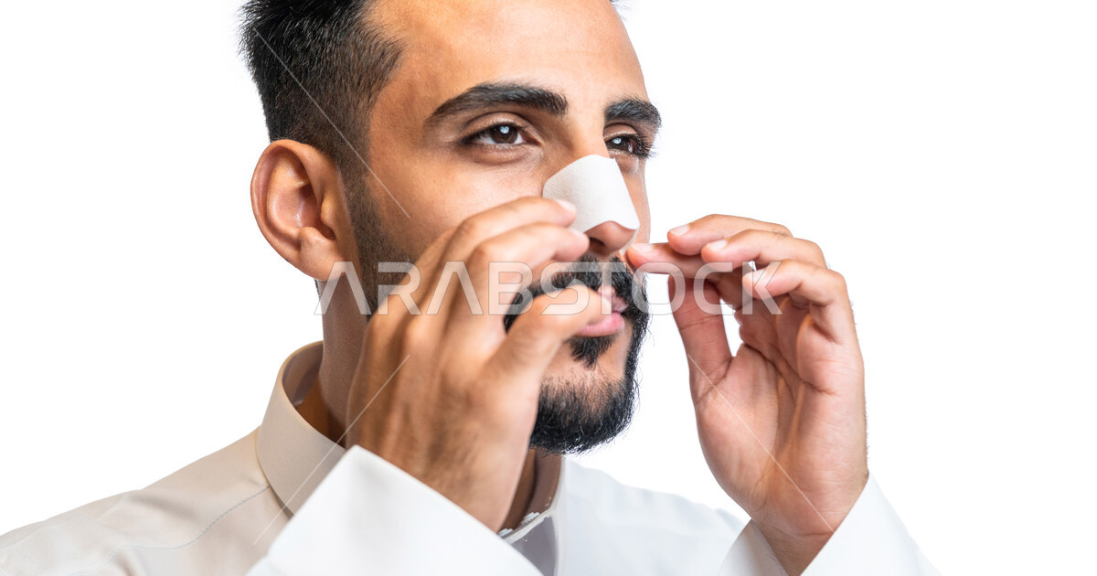 Portrait of a Saudi Arabian Gulf man, who puts nose pads to get rid of ...