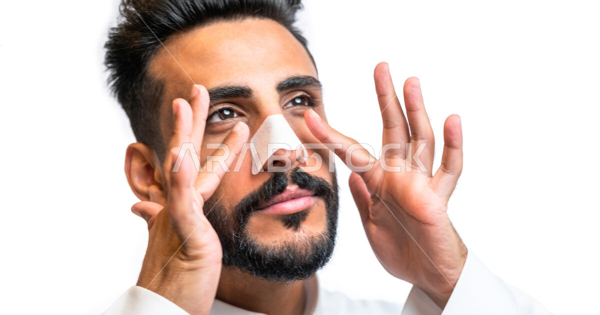 Portrait of a Saudi Arabian Gulf man, who puts nose pads to get rid of ...