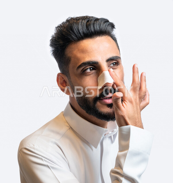 Portrait of a Saudi Arabian Gulf man, who puts nose pads to get rid of ...