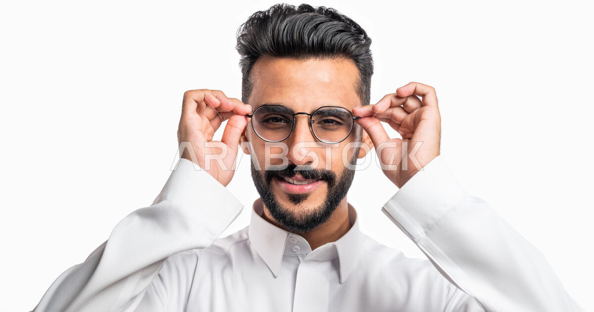 Portrait of a close-up of a smiling Saudi Arabian Gulf man, looking at ...