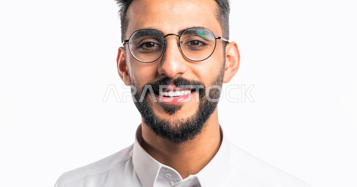 Portrait of a close-up of a smiling Saudi Arabian Gulf man, looking at ...