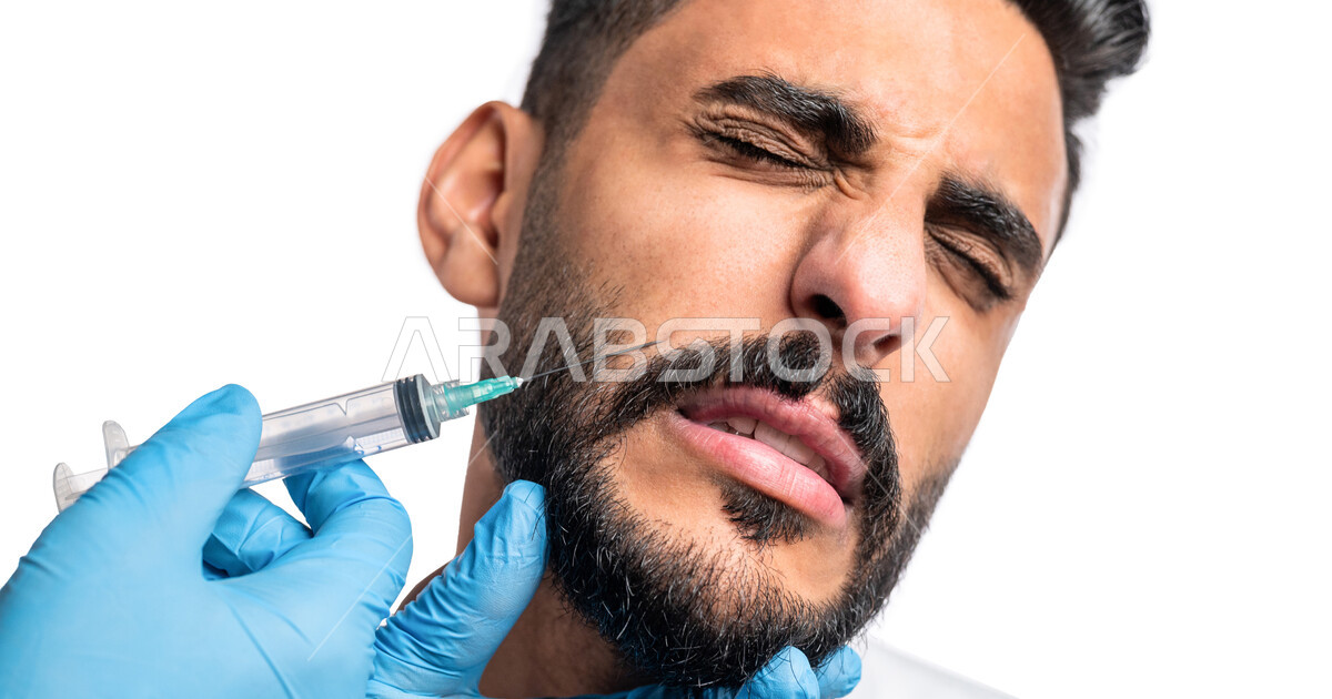 Portrait of a close-up of the hand of a specialist injecting Botox into ...