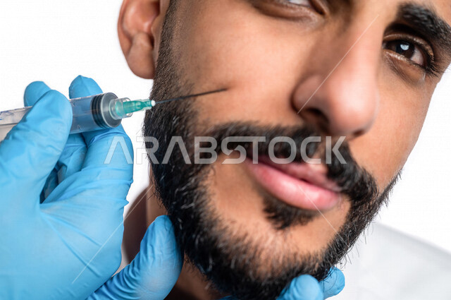 Portrait of a close-up of the hand of a specialist injecting Botox into ...