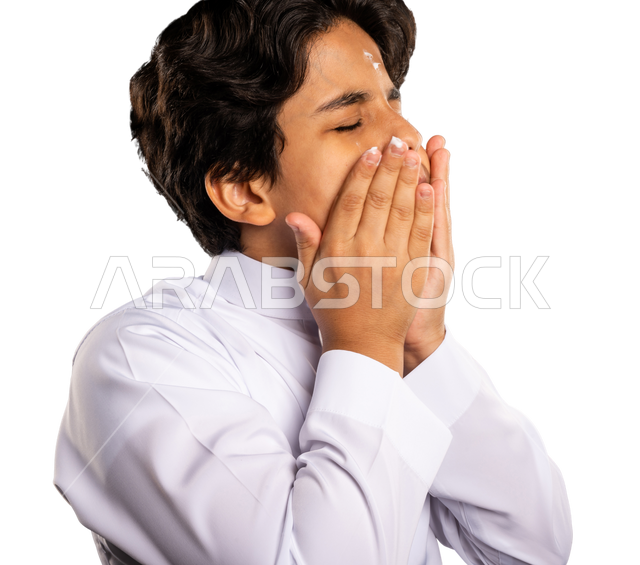 Close-up portrait of a Saudi Arabian Gulf boy wearing the Saudi dress ...