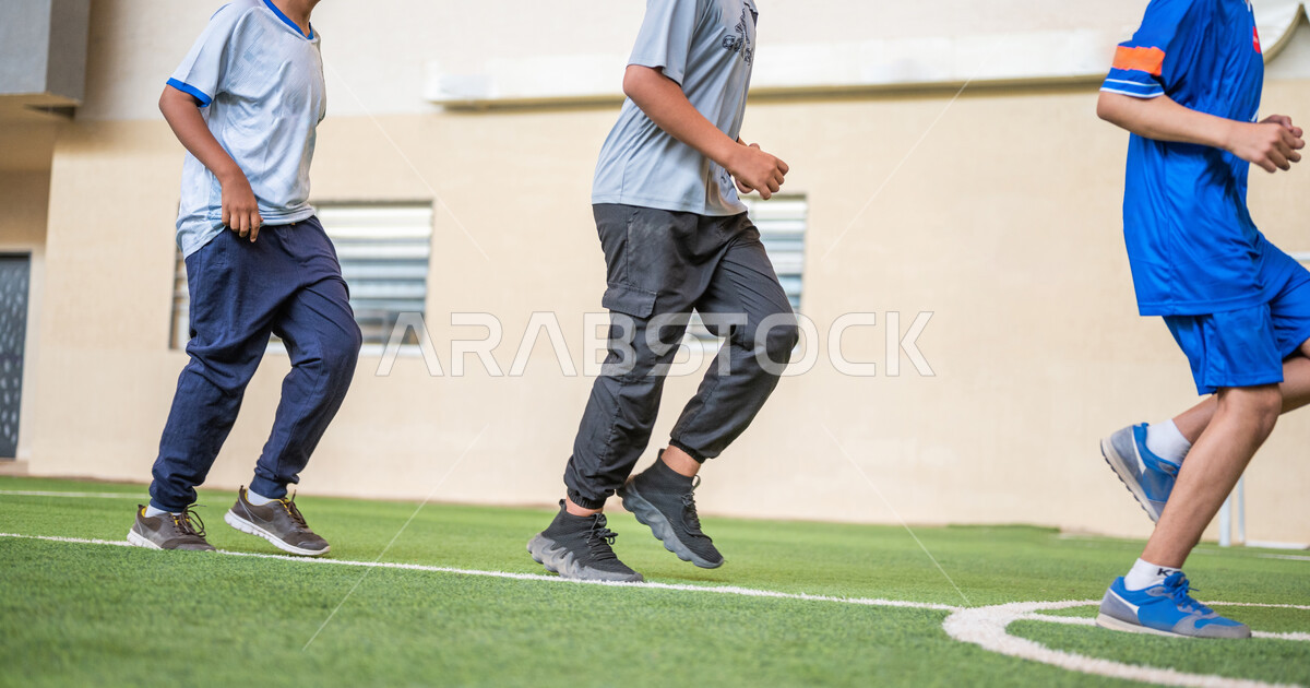 Saudi Gulf Arab students performing warm-up exercises, running in the ...