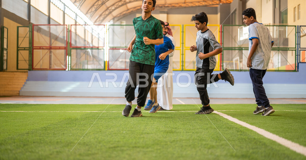Saudi Gulf Arab students performing warm-up exercises, running in the ...
