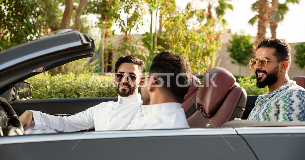 A close-up photo of a group of young Saudi Arabs from the Gulf on a car ...