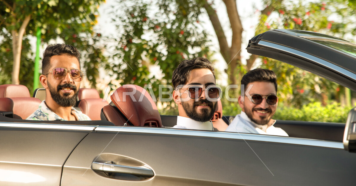 A close-up photo of a group of young Saudi Arabs from the Gulf on a car trip, a luxury ...
