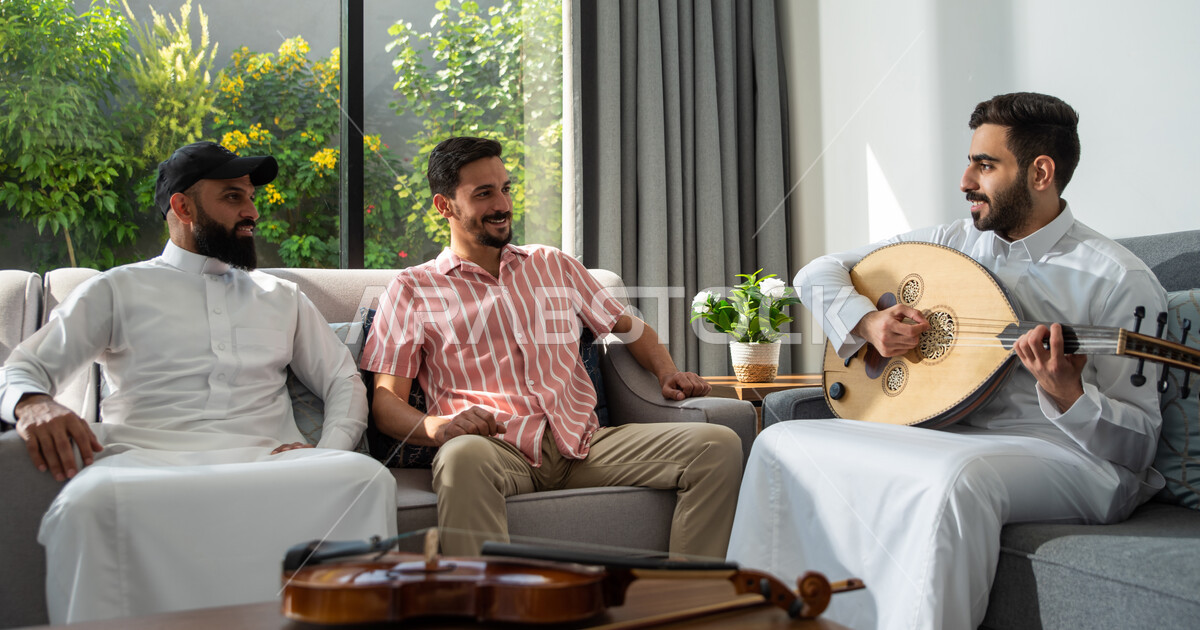 A group of Saudi Arab friends sitting at home, playing the oud ...