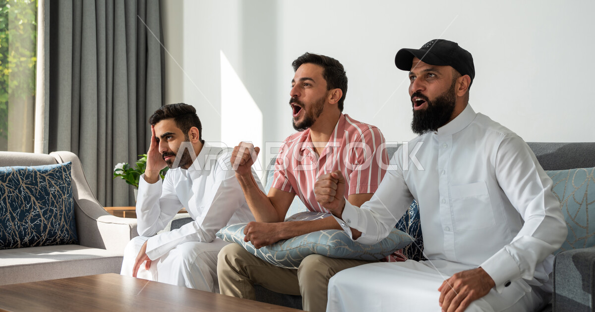 A group of Saudi Arab friends sitting at home, expressions of ...