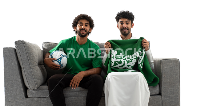 Portrait of two young Saudi Arabian Gulf men, one of them holding a ...