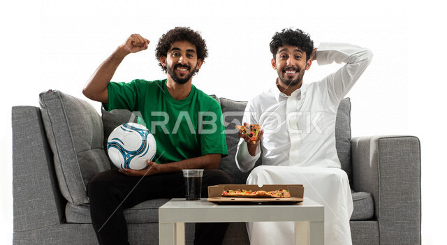 Portrait of two Saudi Arabian Gulf youths enjoying watching the ...