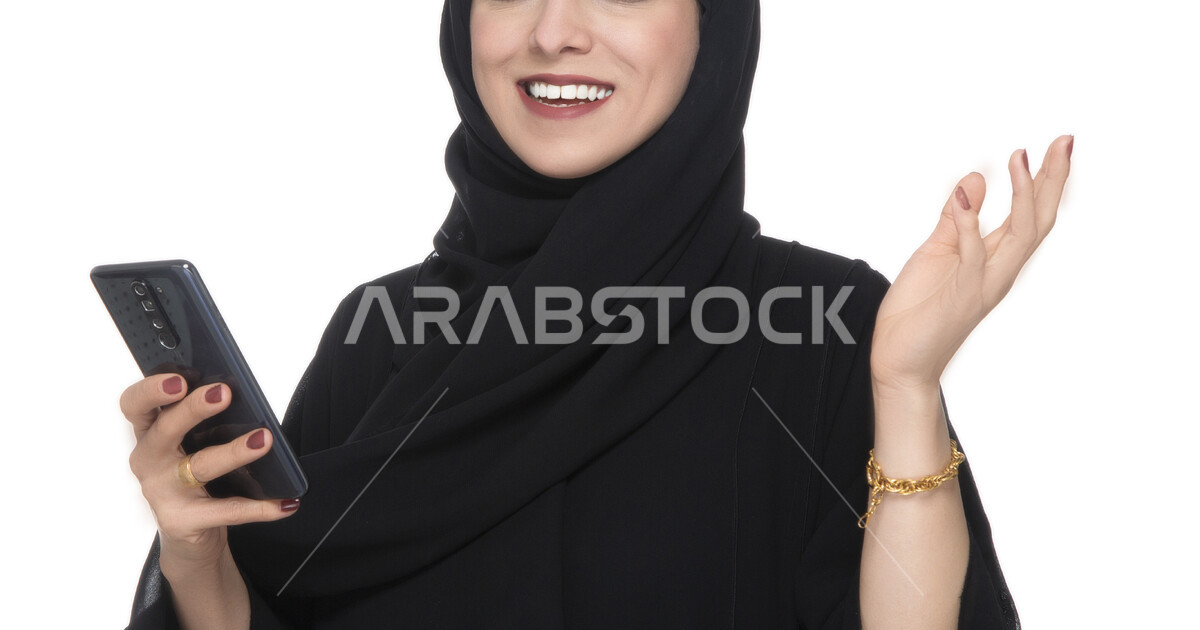 Portrait of an Arab Gulf Emirati businesswoman, using a mobile phone ...