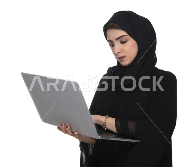Portrait of an Emirati woman working on a laptop, Emirati company, Gulf ...