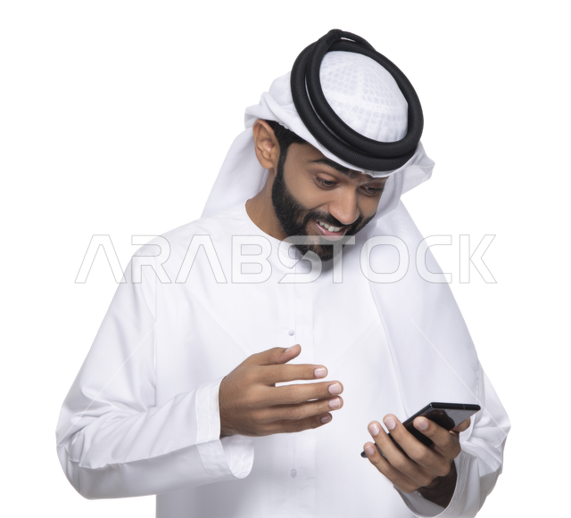 Portrait of an Arab Gulf Emirati youth using a mobile phone, facial ...