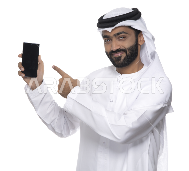 Portrait of an Arab Gulf Emirati youth using a mobile phone ...