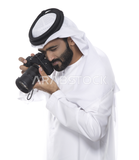Portrait of an Emirati Arab Gulf youth, holding a photography camera in ...