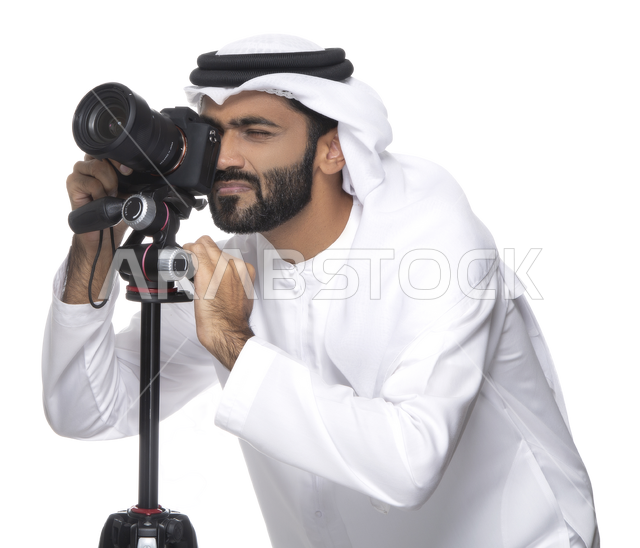 Portrait of an Emirati Arab Gulf youth, holding a photography camera in ...