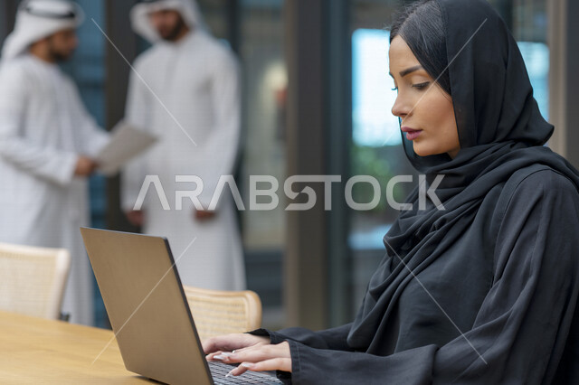 A close-up image of an Arab Emirati Gulf businesswoman sitting at the ...