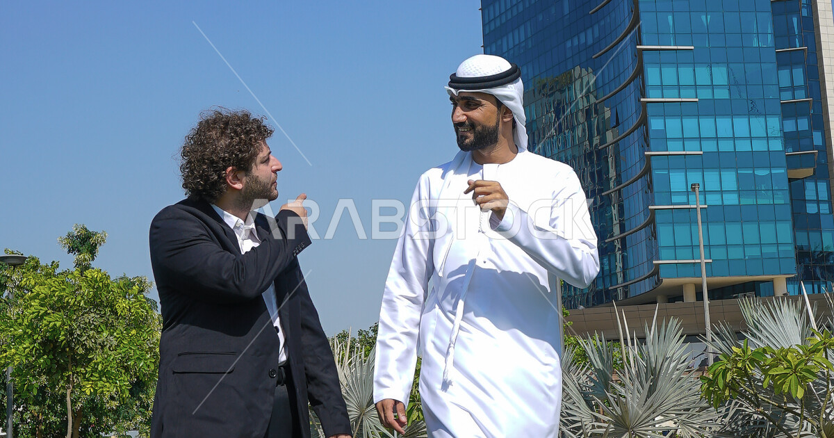 An Arab Gulf Emirati businessman meets a customer wearing a formal suit ...