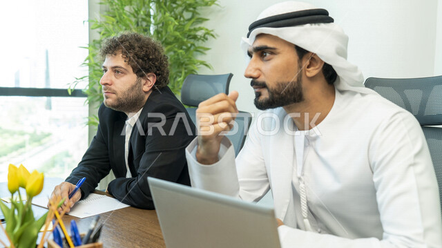 An Arab Gulf Emirati businessman in a business meeting with a new ...