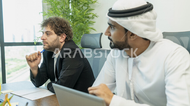 An Arab Gulf Emirati businessman in a business meeting with a new ...