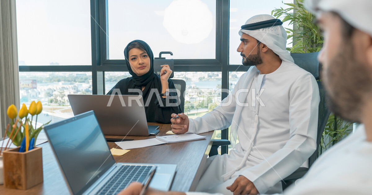 Arab Gulf Emirati team in a business meeting, meeting room, businessmen ...