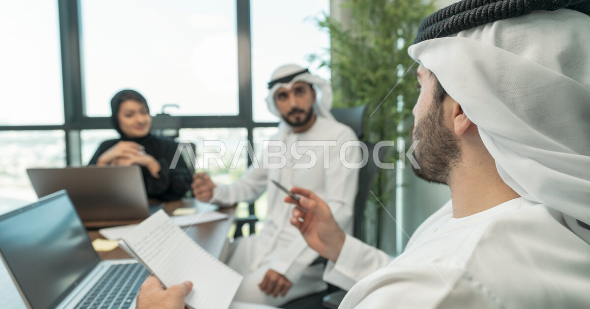Arab Gulf Emirati team in a business meeting, meeting room, businessmen ...