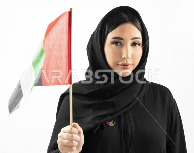 Portrait of an Emirati Arab Gulf woman, wearing the Gulf abaya, holding ...