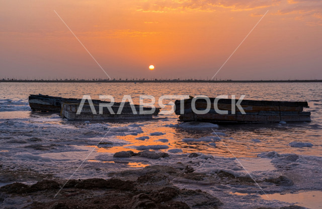 Golden sunset in the sky of Jeddah on the Red Sea, boats gathering on ...