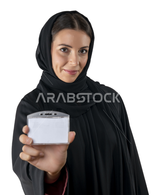 Portrait of a smiling, veiled Emirati Arab Gulf woman, holding a blank ...