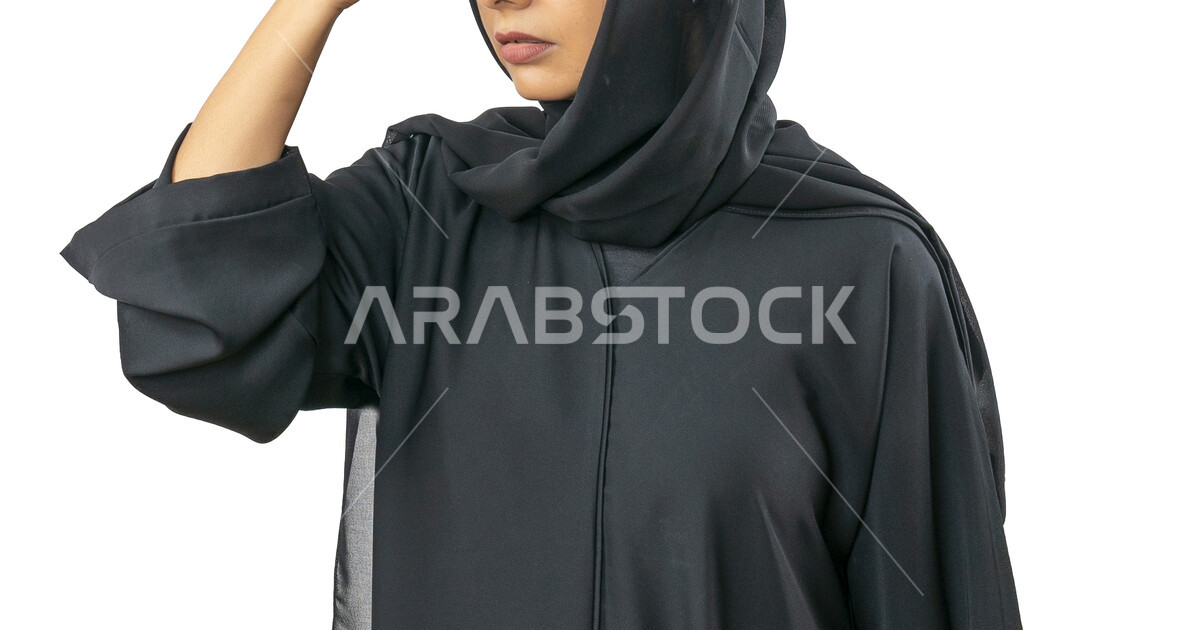 Portrait of an Arab Emirati Gulf woman wearing abaya and hijab, making facial gestures ...