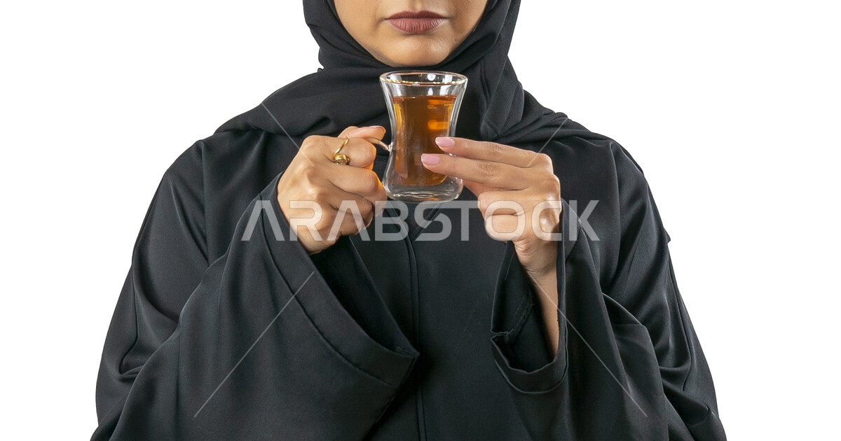 Portrait of an Emirati Arab Gulf woman wearing an abaya, drinking hot ...