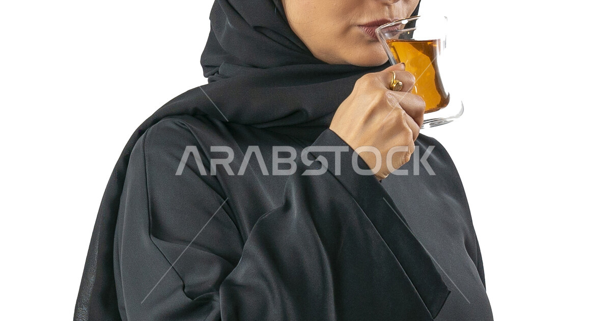 Portrait of an Emirati Arab Gulf woman wearing an abaya, drinking hot ...