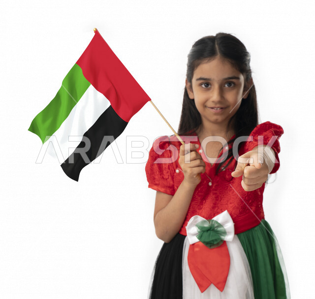 A girl holding the UAE flag in her hand, celebrating the Independence ...