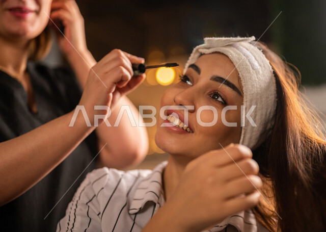 A Saudi Arabian Gulf woman applying one of the cosmetics (mascara) in ...