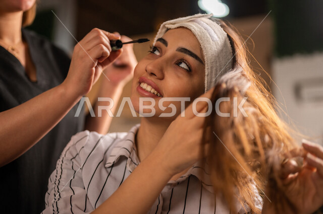 A Saudi Arabian Gulf woman applying one of the cosmetics (mascara) in ...
