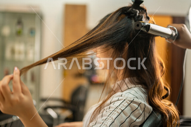 A corner from the back of a Saudi Arabian Gulf woman in a women’s ...