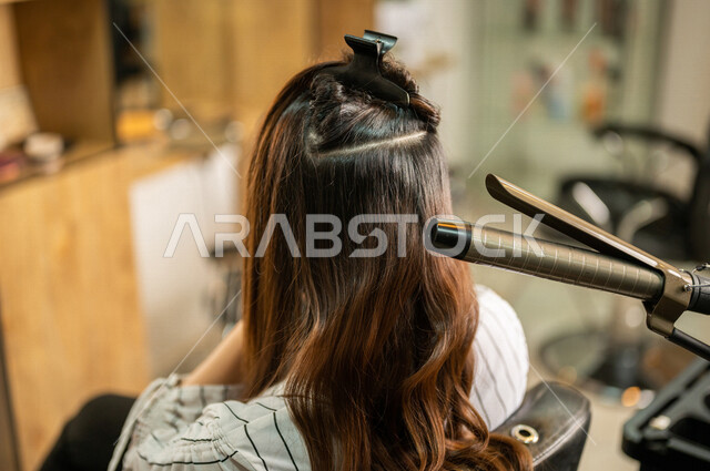 A corner from the back of a Saudi Arabian Gulf woman in a women’s ...