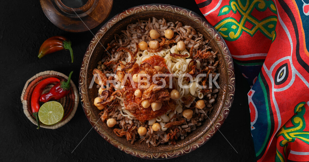 A dish of rice and pasta decorated with hot sauce, delicious Egyptian ...