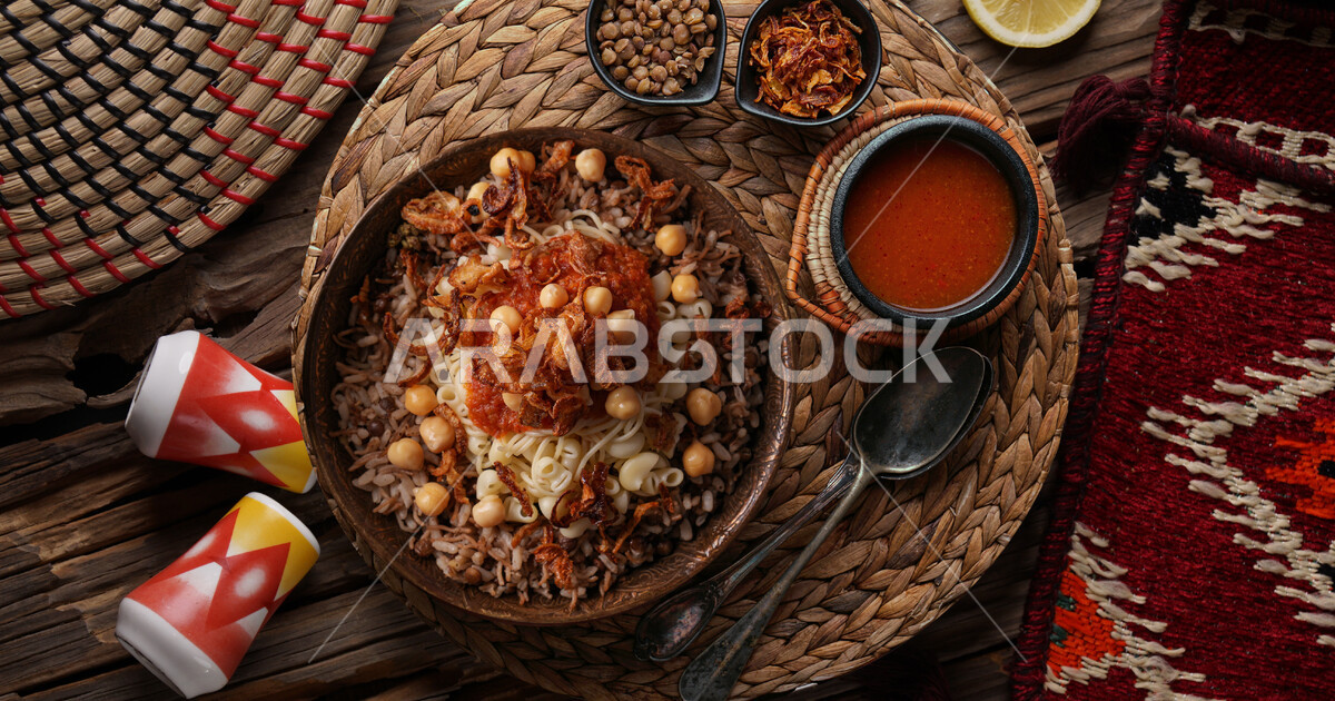 A dish of rice and pasta decorated with hot sauce, delicious Egyptian ...