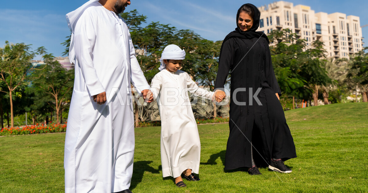 An Arab-Emirati-Gulf family consisting of three members, an Emirati ...
