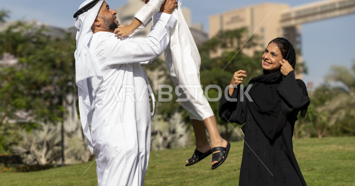 An Arab Emirati Gulf family consisting of three members, an Emirati ...