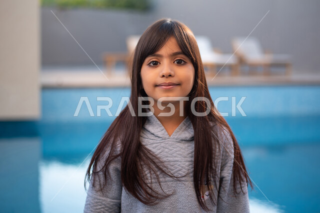 Close-up of a Saudi Arabian Gulf girl, smiling, looking at the camera ...