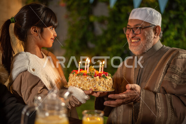 A Saudi Arab Gulf girl celebrates her birthday with her grandfather in ...