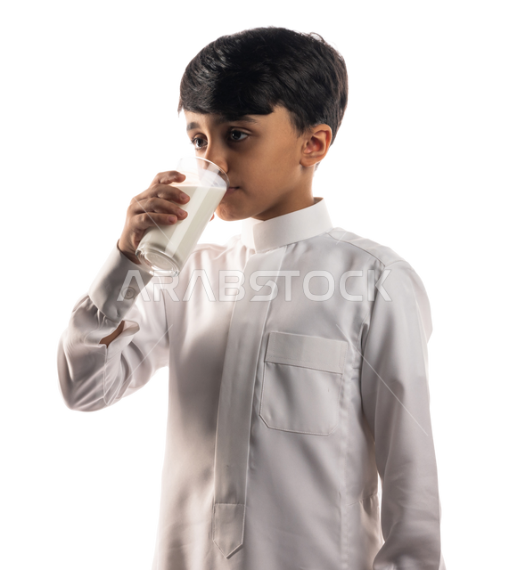Portrait of a Saudi Arabian Gulf boy drinking milk, healthy breakfast ...