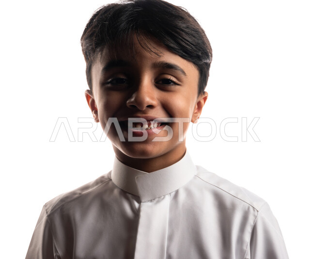 Portrait of a smiling Saudi Arabian Gulf boy, looking at the camera ...
